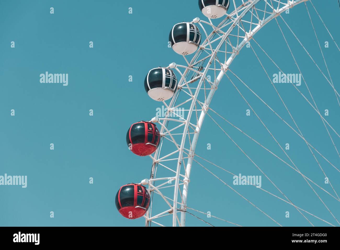 Red and white booths on a white Ferris wheel against the sky Stock ...