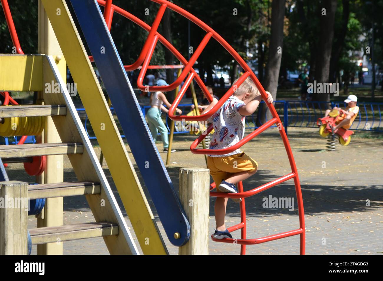 Little children run around and play in the playground Stock Photo - Alamy