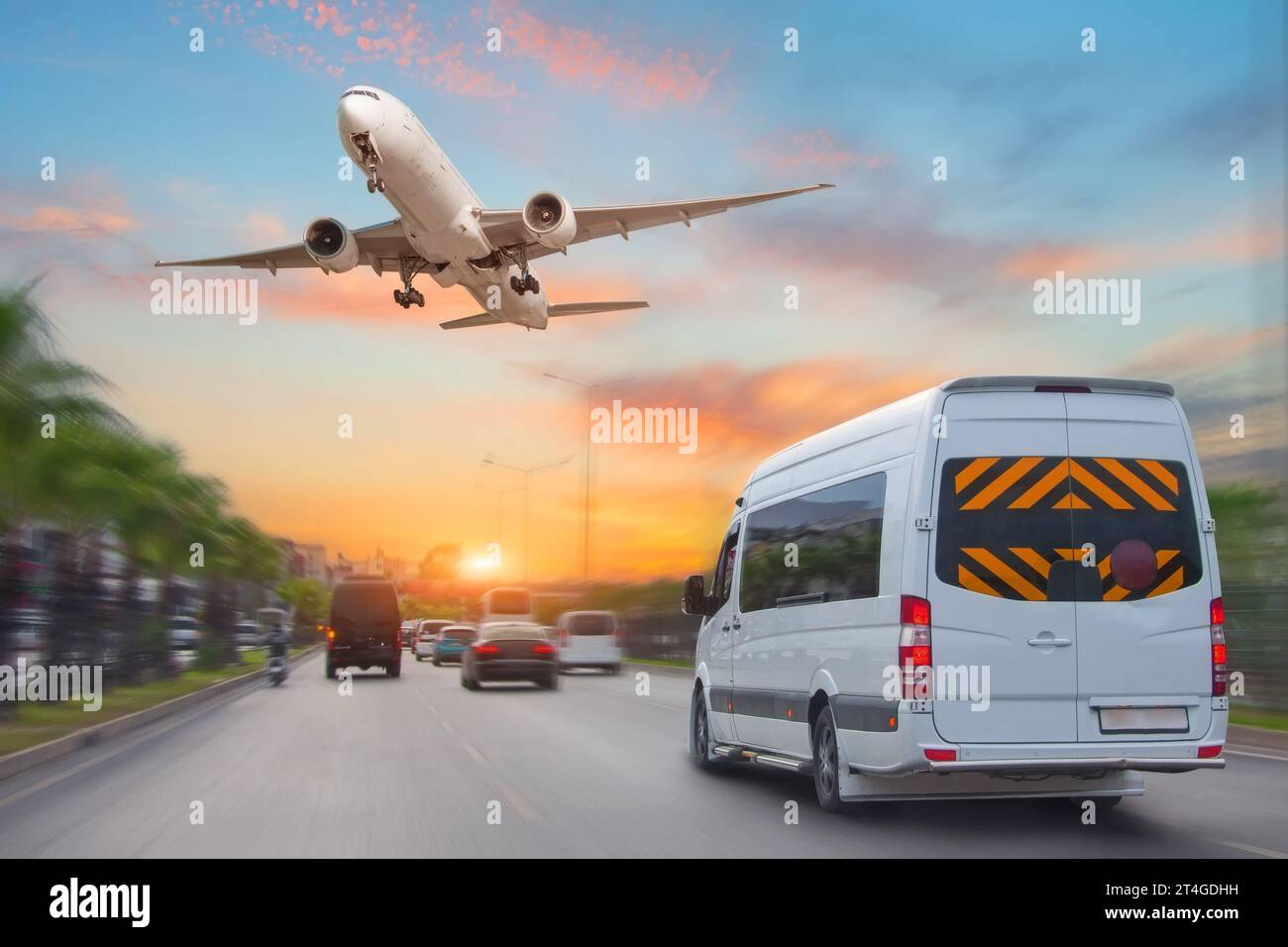 Mini bus drives along the highway among other cars in the evening in ...