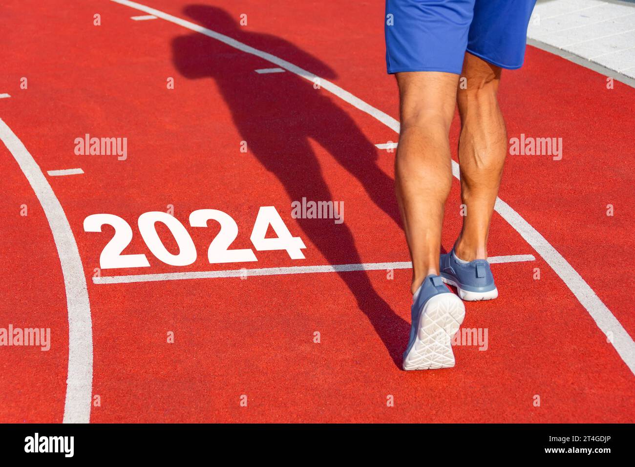 Runner crosses the line starting in 2024 on a red treadmill with the ...