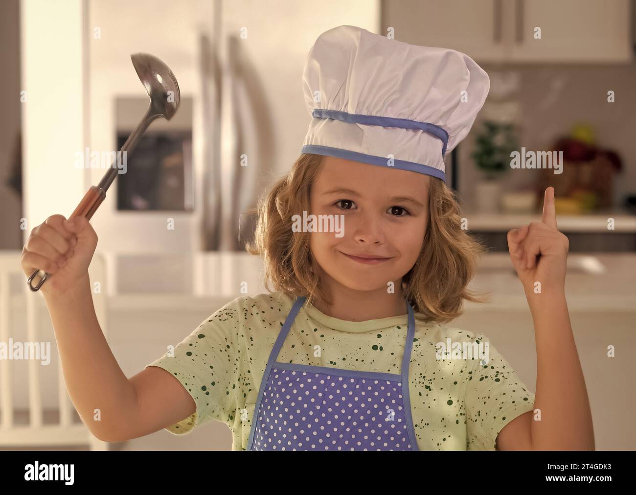 Children cooking in the kitchen. Funny kid chef cook cookery at kitchen ...