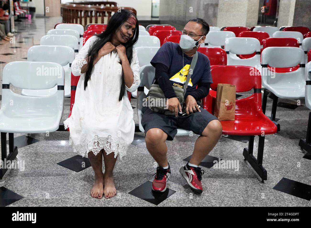 A staffer for the National Blood Center dressed in ghost costumes sits ...