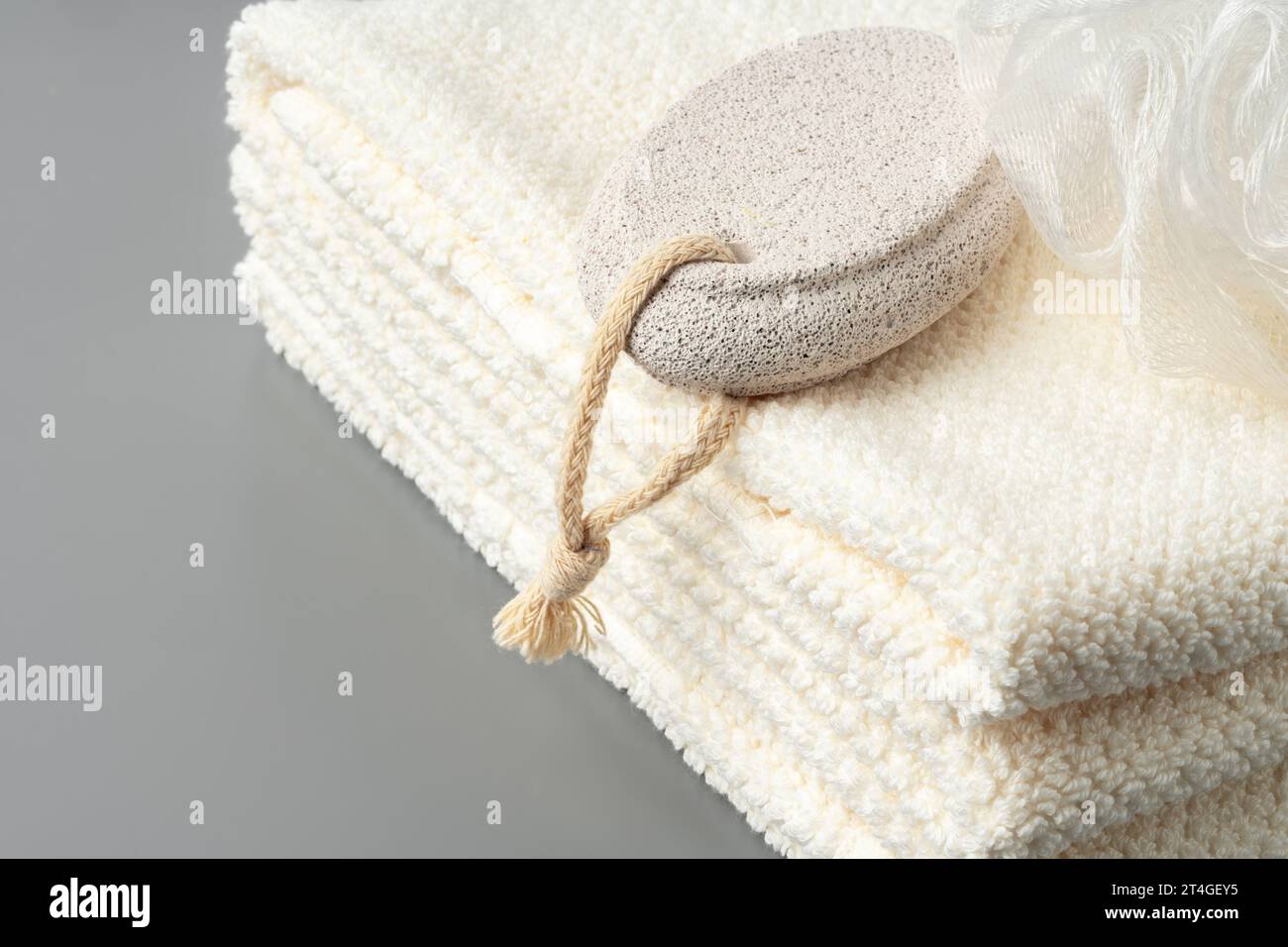 Pumice stone and stacked towels in a bathroom Stock Photo - Alamy