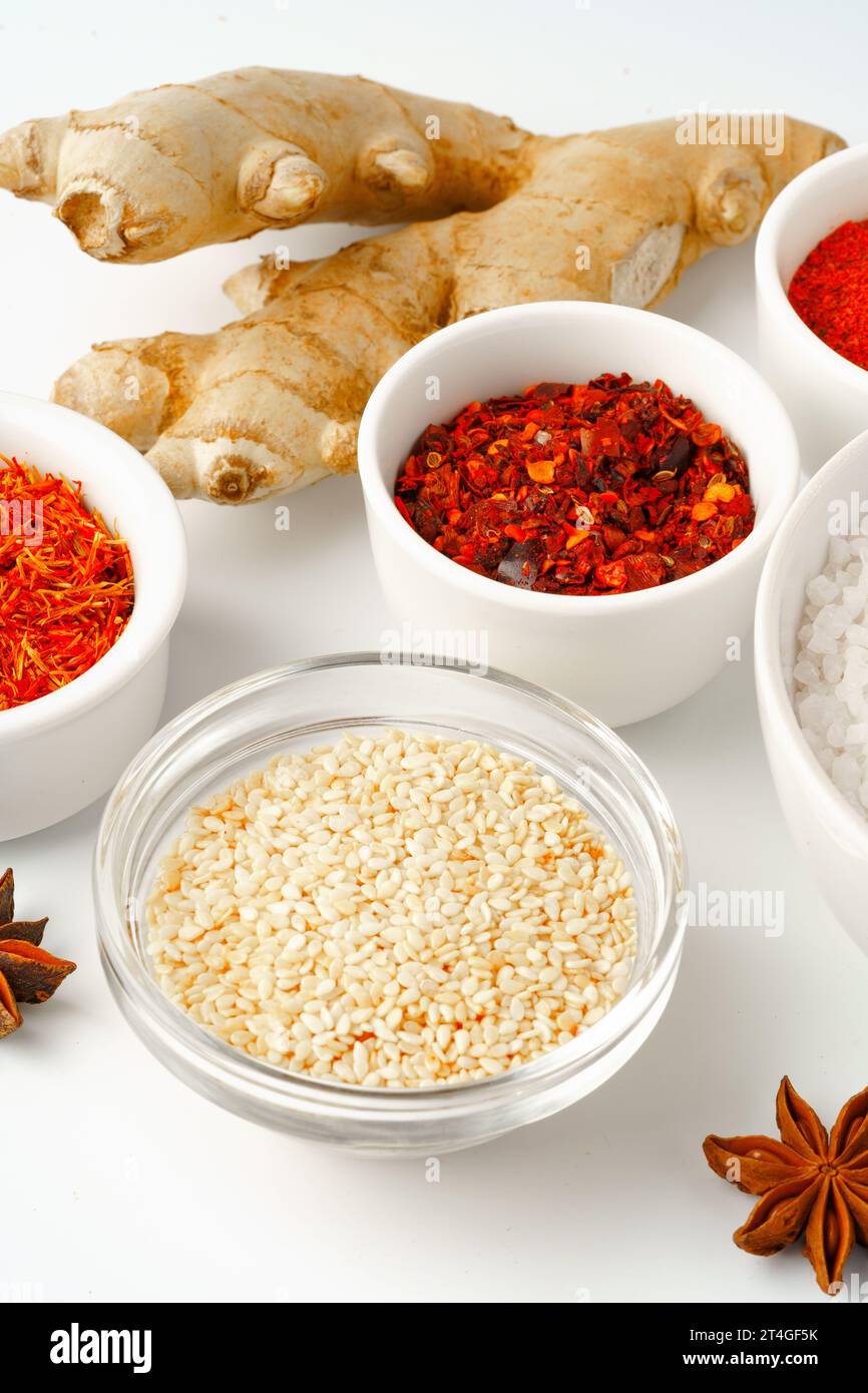 Ginger root and various spices on white background Stock Photo - Alamy