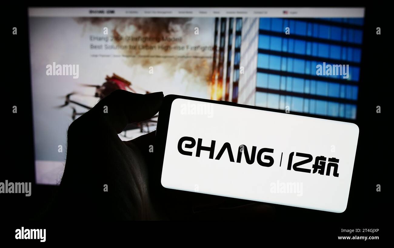 Person holding cellphone with logo of Chinese aviation company EHang ...