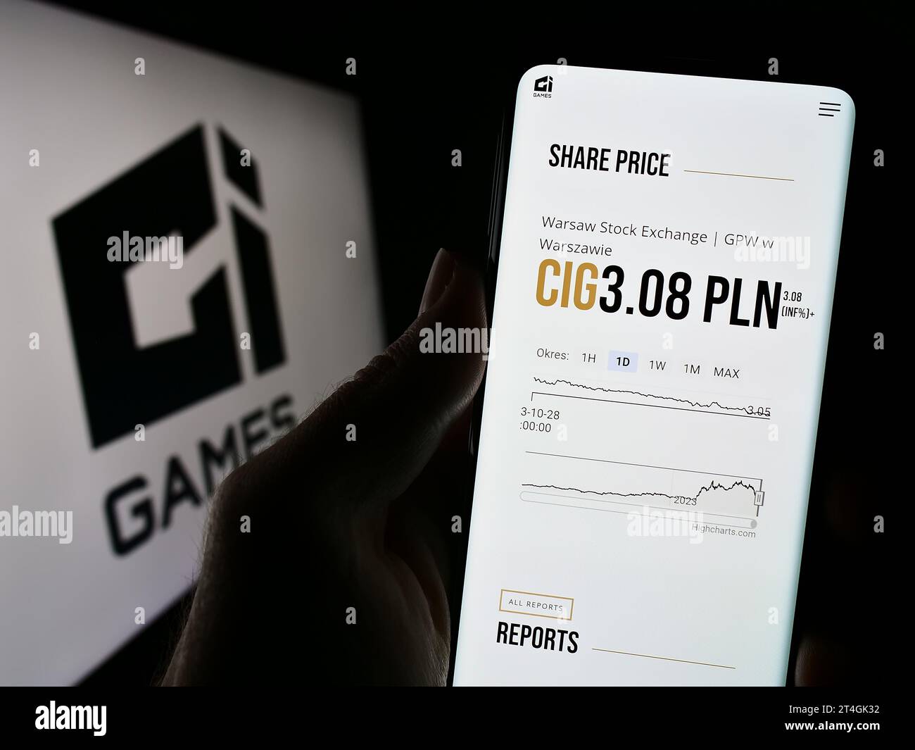 Person holding smartphone with webpage of Polish video games company CI Games SA in front of ...
