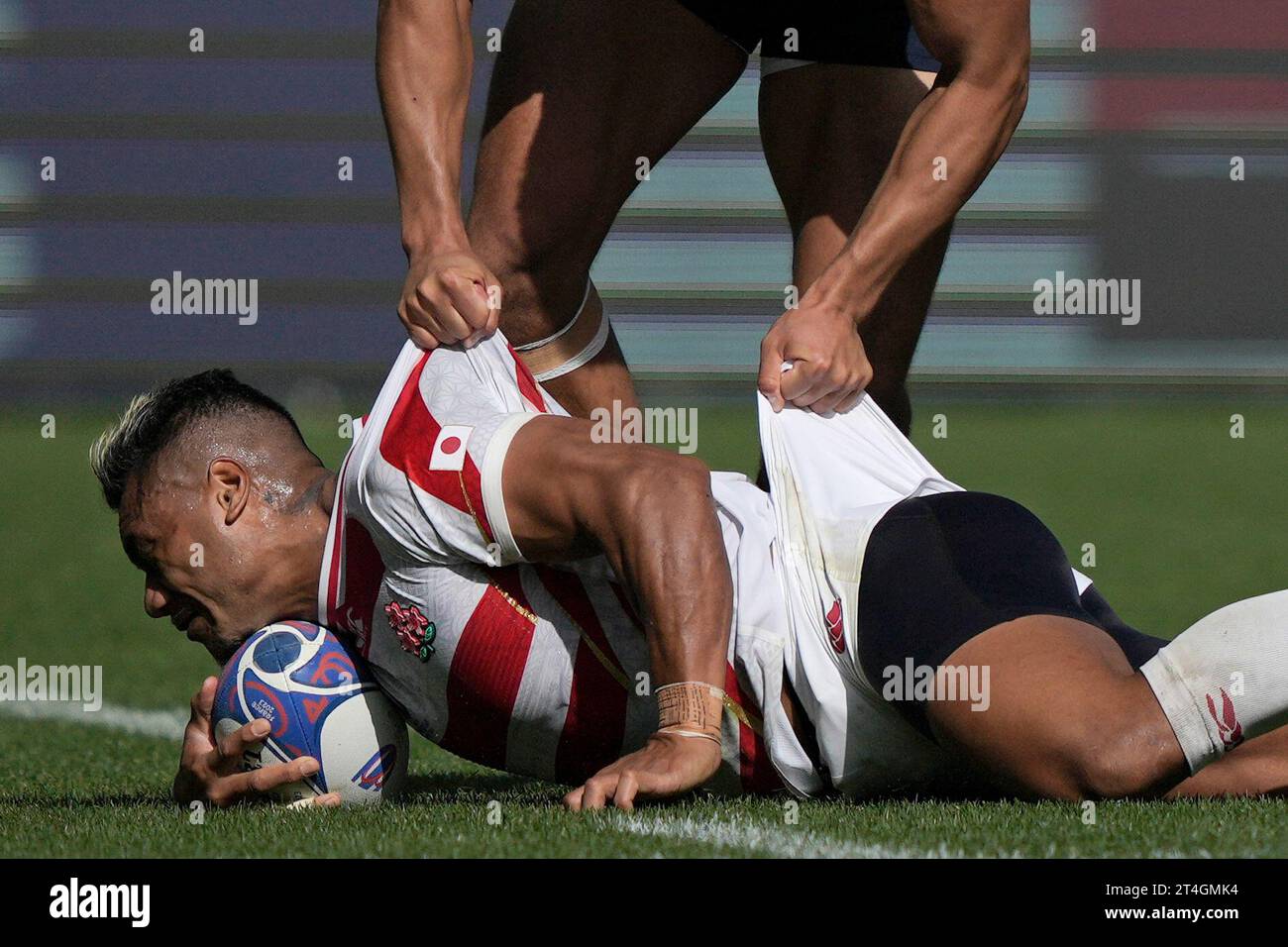 Japan's Lomano Lemeki, below, is tackled by Argentina's Tomas Lavanini ...
