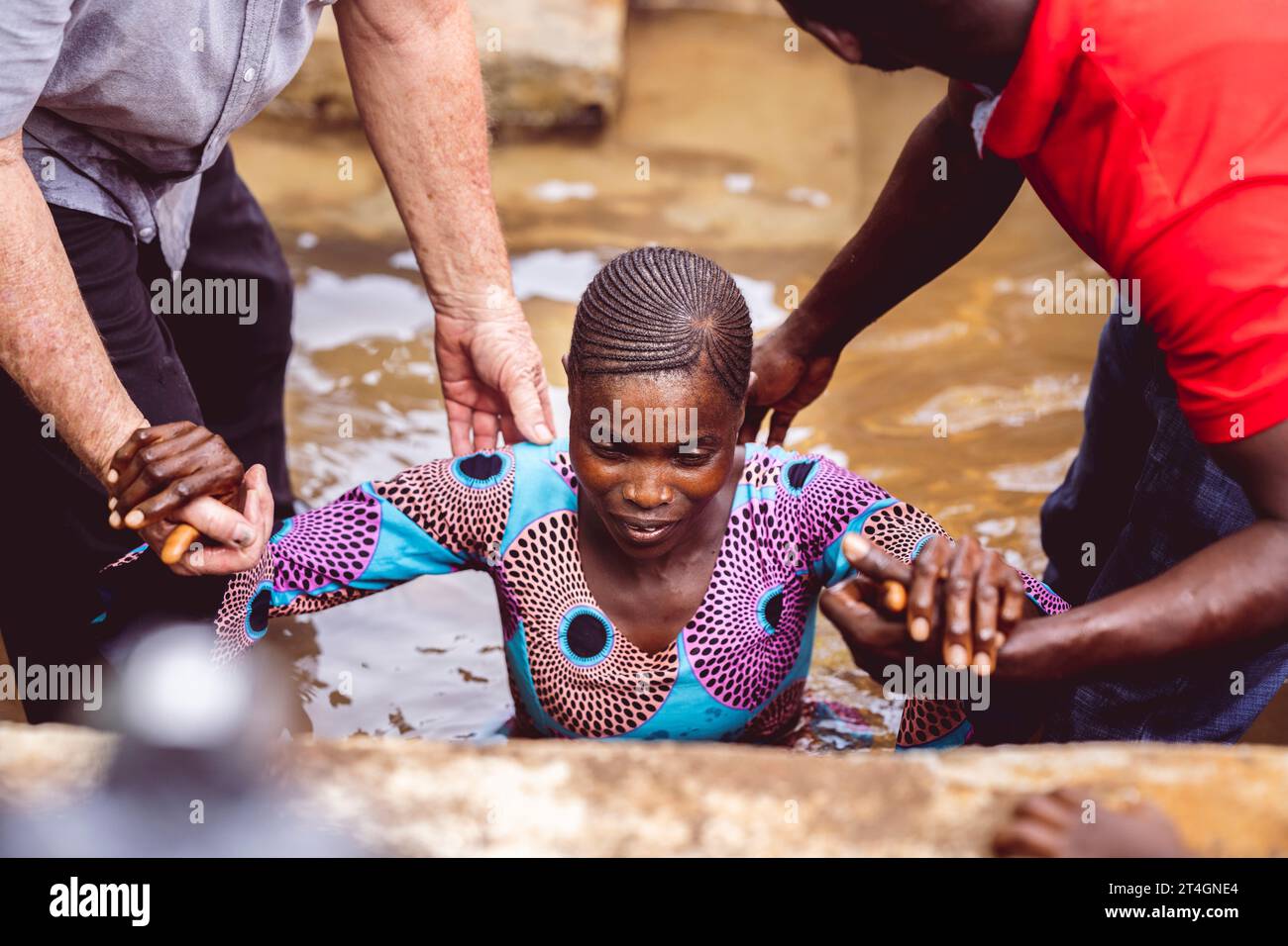 A group of joyous people celebrating a religious baptism ceremony in ...