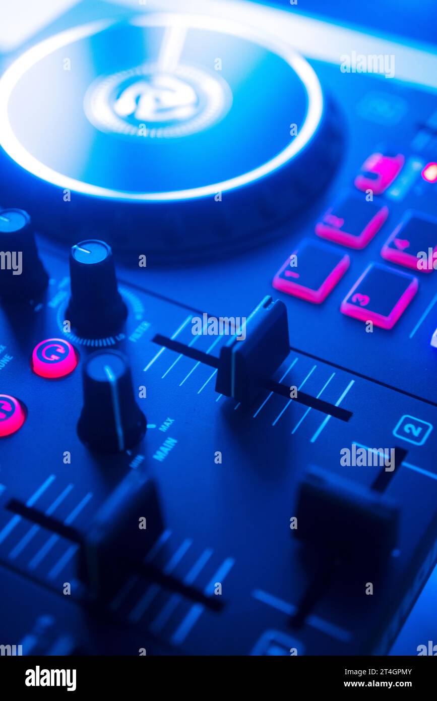DJ mixing desk turntable in colored wedding disco party lights Stock ...