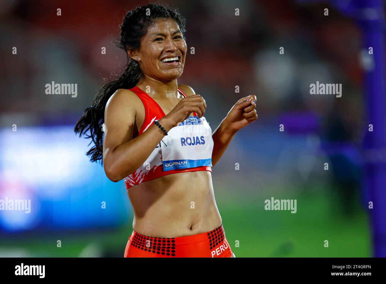 Luz Rojas, from team Peru, crosses the finish line in first place in the women's 10,000 m final ...