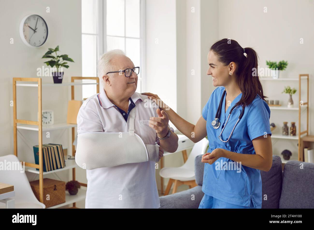 Friendly doctor giving her help and support to a senior patient with a ...