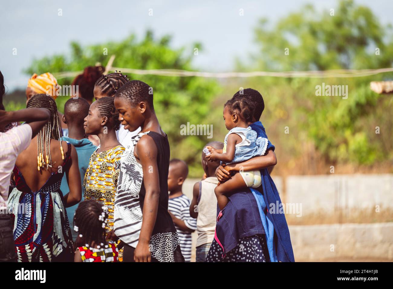 A group of people together in the bright sunshine of Abidjan, Cote d ...