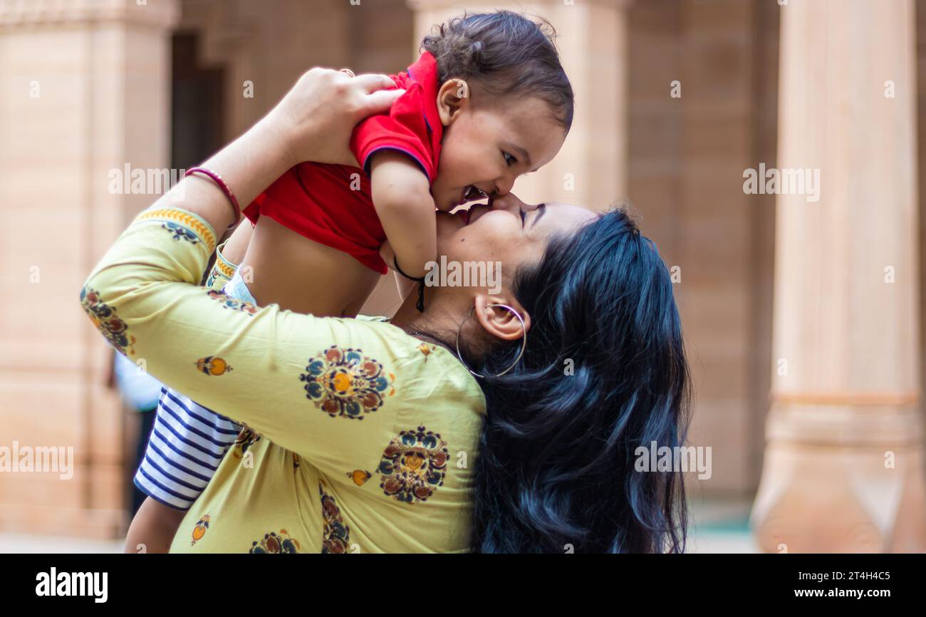 cute toddler baby boy smiling at mother hand and touch in casual ...