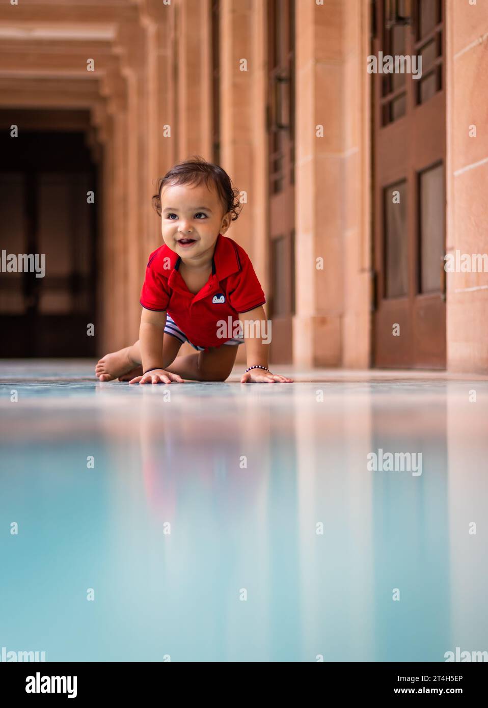 Sitting smiling looking down childhood innocence hi-res stock ...