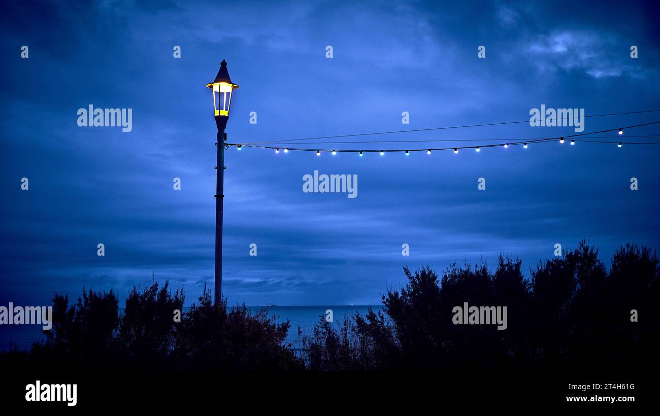 Solitary lamp post set againt a stormy sky in Blackpool during the ...