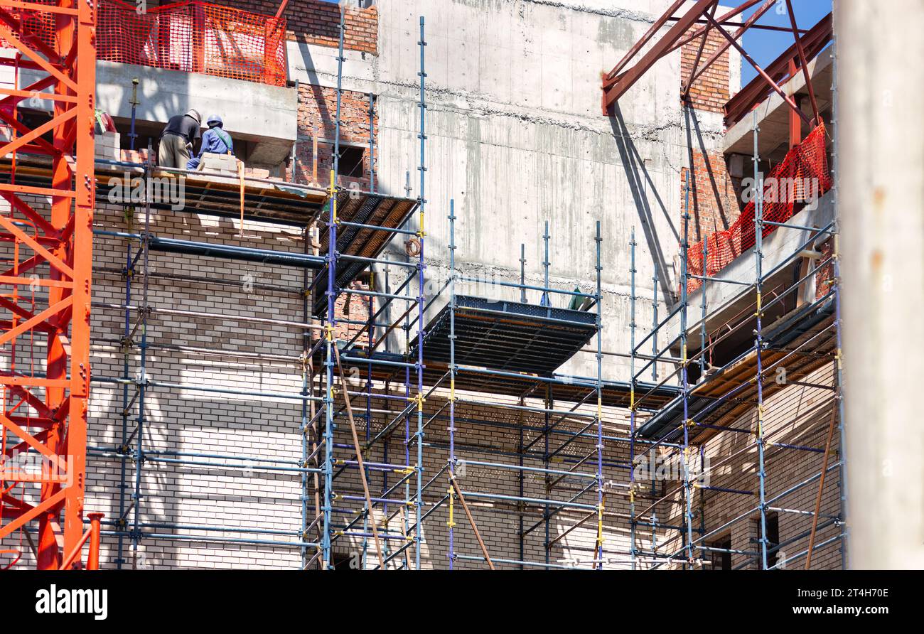 african american workers working on the scaffolding at a construction ...
