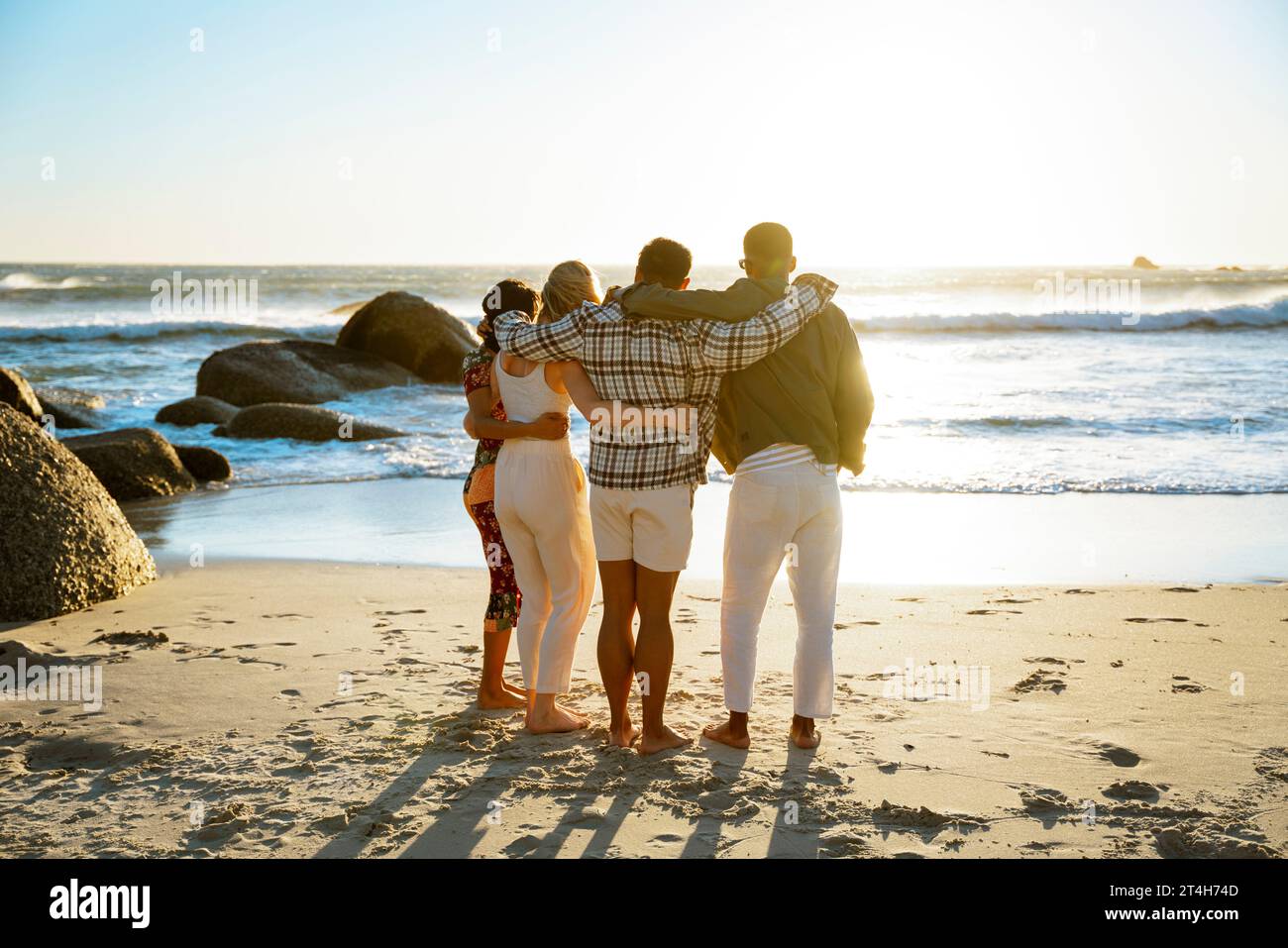 Friends Standing Together Watching the Sunset Stock Photo - Alamy
