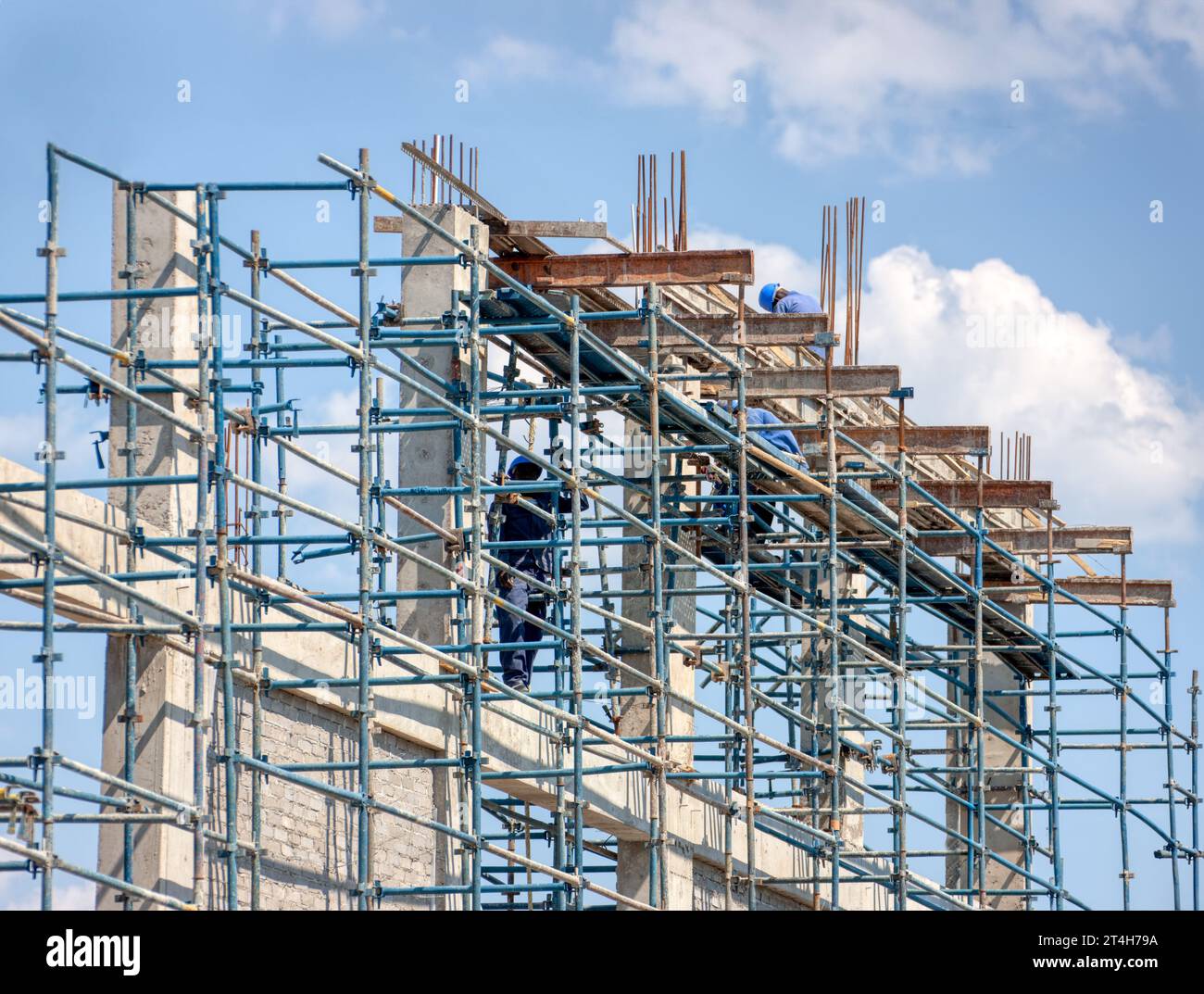 african american workers climbed on the scaffolding at a construction ...