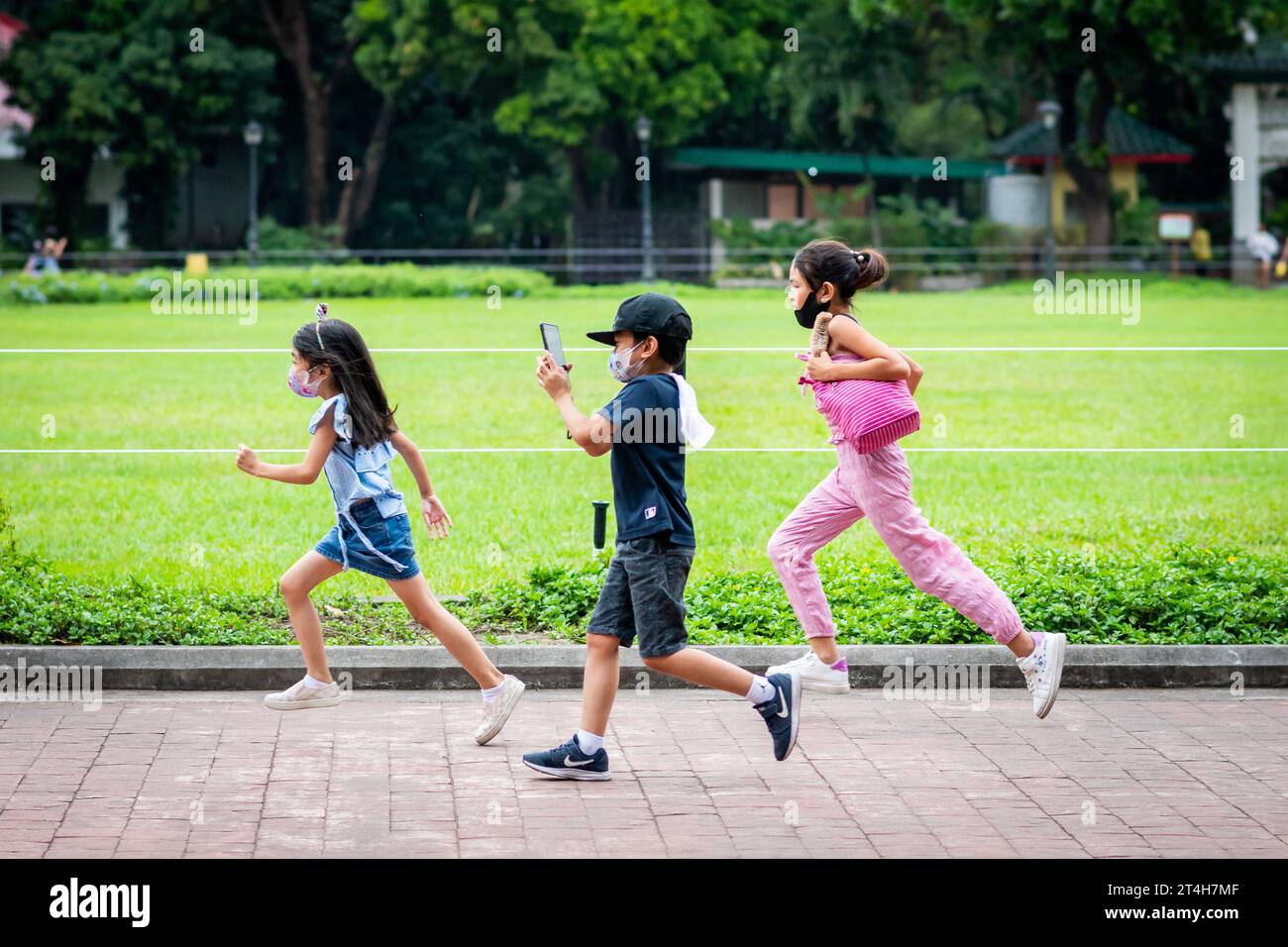 Children at play running through Rizal Park, Ermita, Manila, The ...