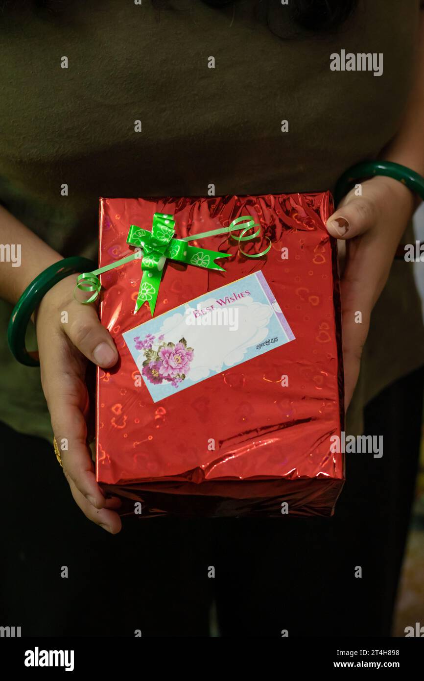 gift pack holding at hand from flat angle Stock Photo - Alamy