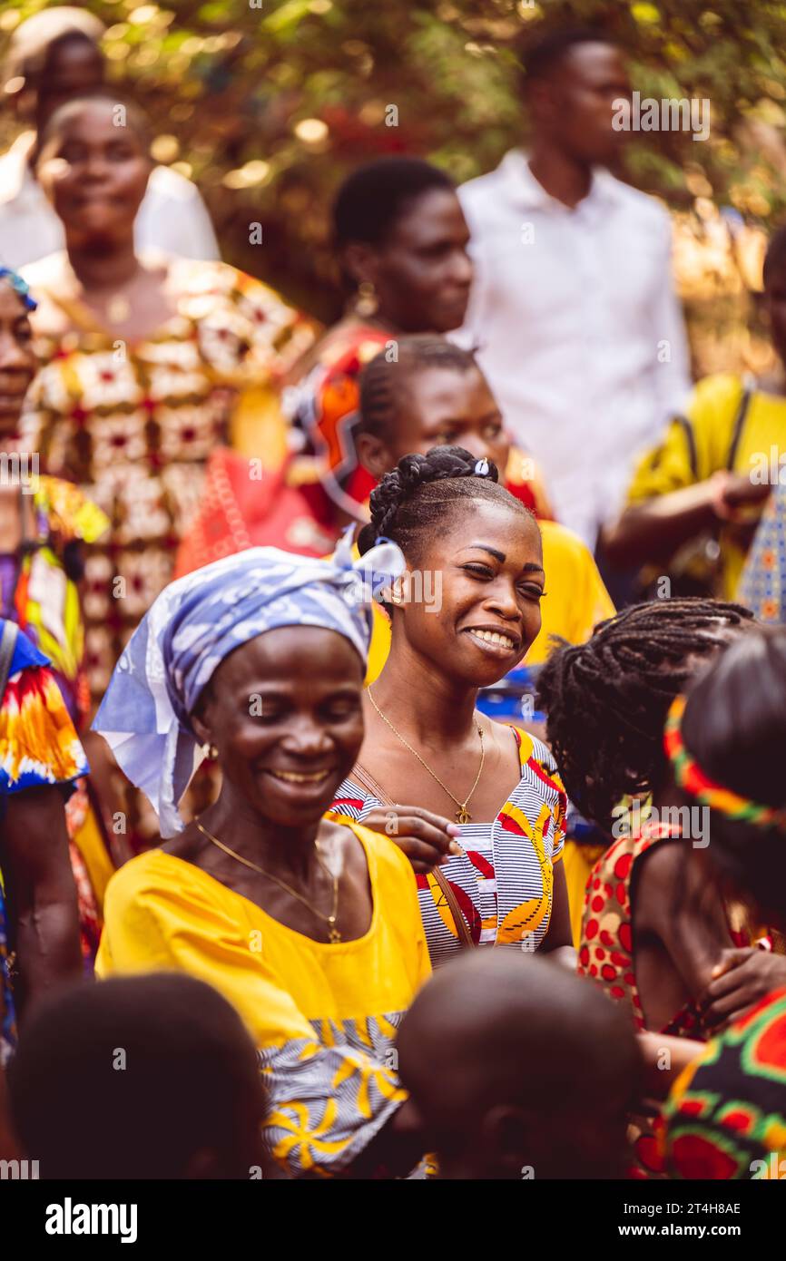 A joyful group of people together in the bright sunshine of Abidjan ...
