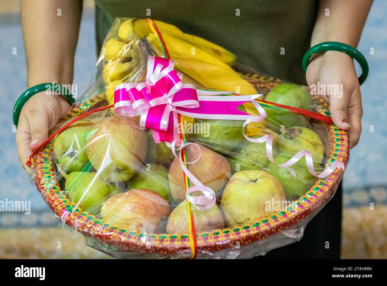 fruit gift wrap filled with different fruits and gift pack holding at ...