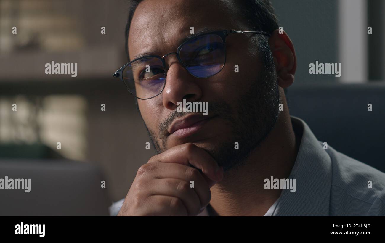Close up Indian man in glasses Arabian businessman with laptop thinking ...