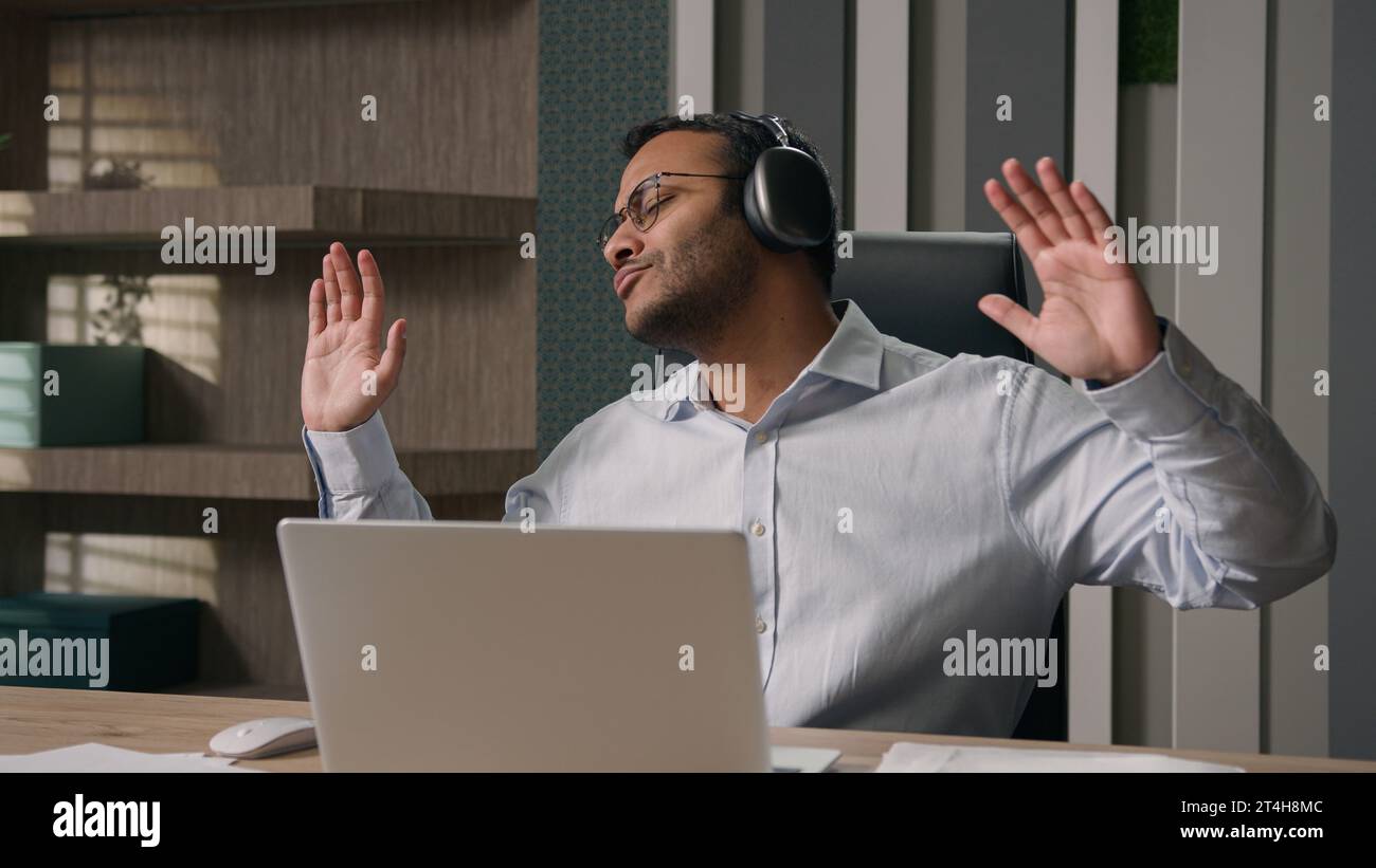 Happy employer at office table with computer laptop enjoying rest break ...
