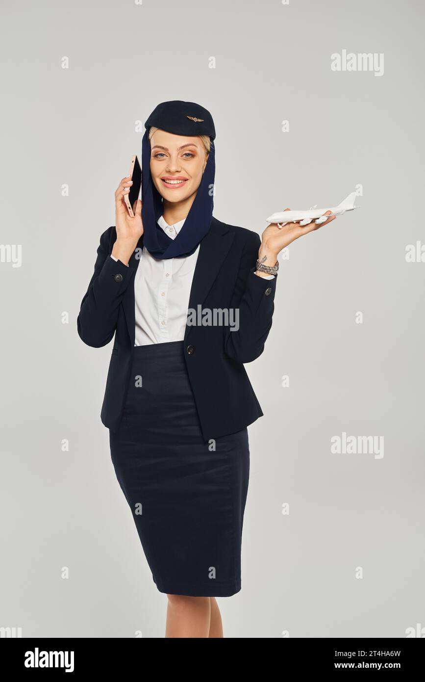 elegant arabian airlines stewardess with airplane model talking on ...