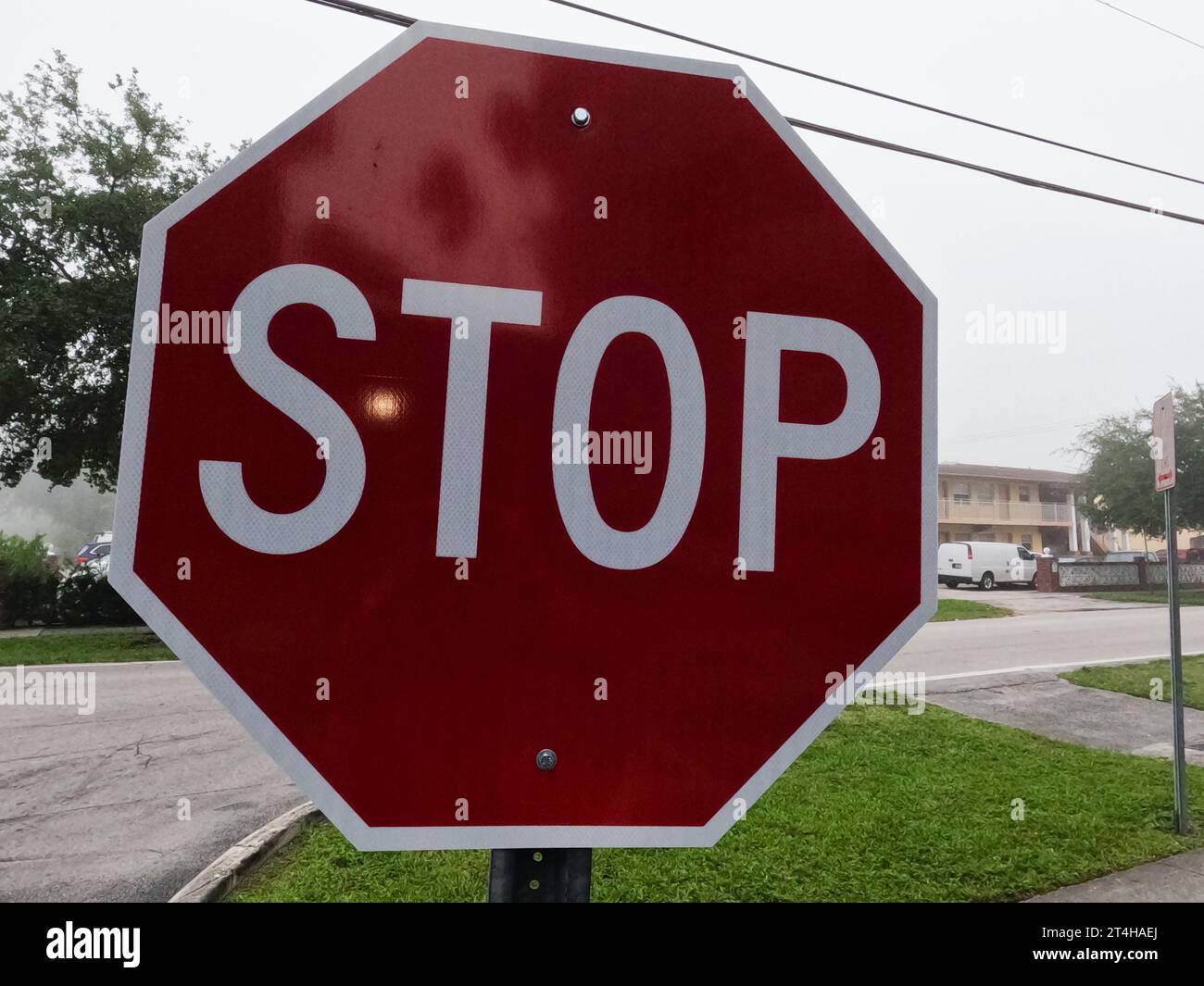 stop sign at the side of a road Stock Photo - Alamy