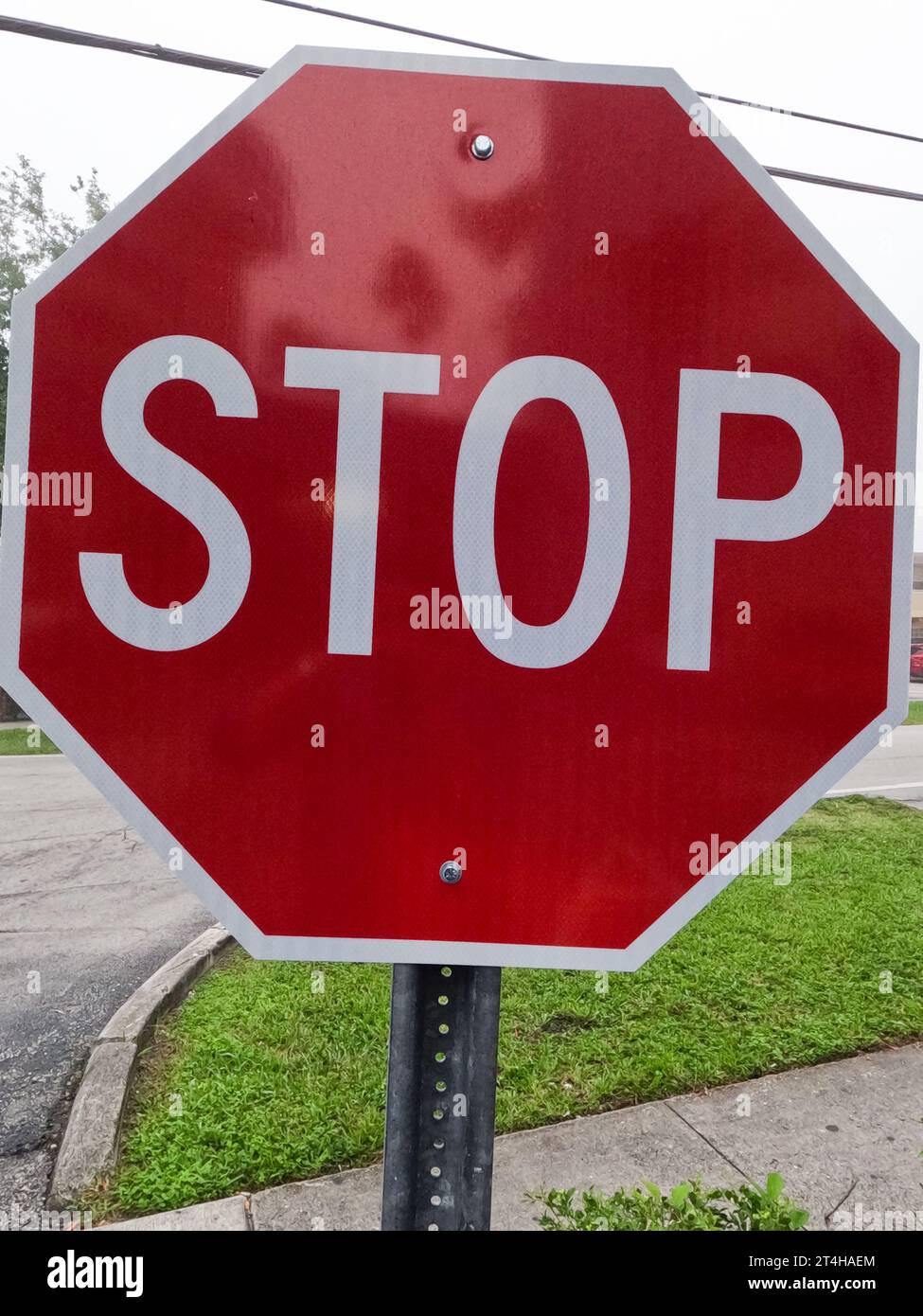 stop sign at the side of a road Stock Photo - Alamy