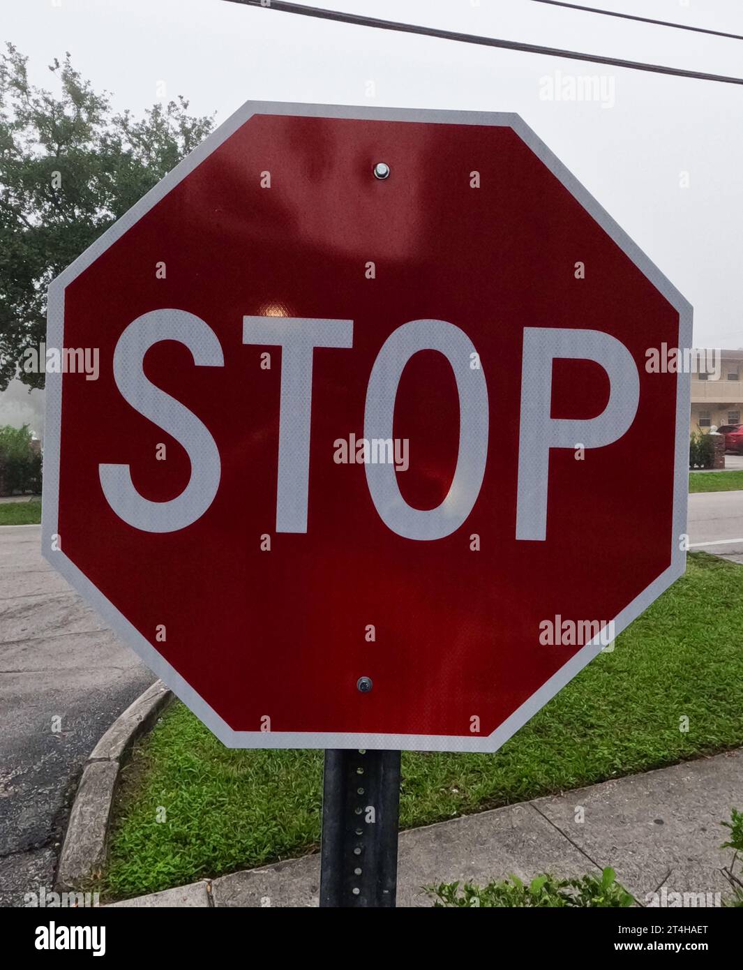 stop sign at the side of a road Stock Photo - Alamy