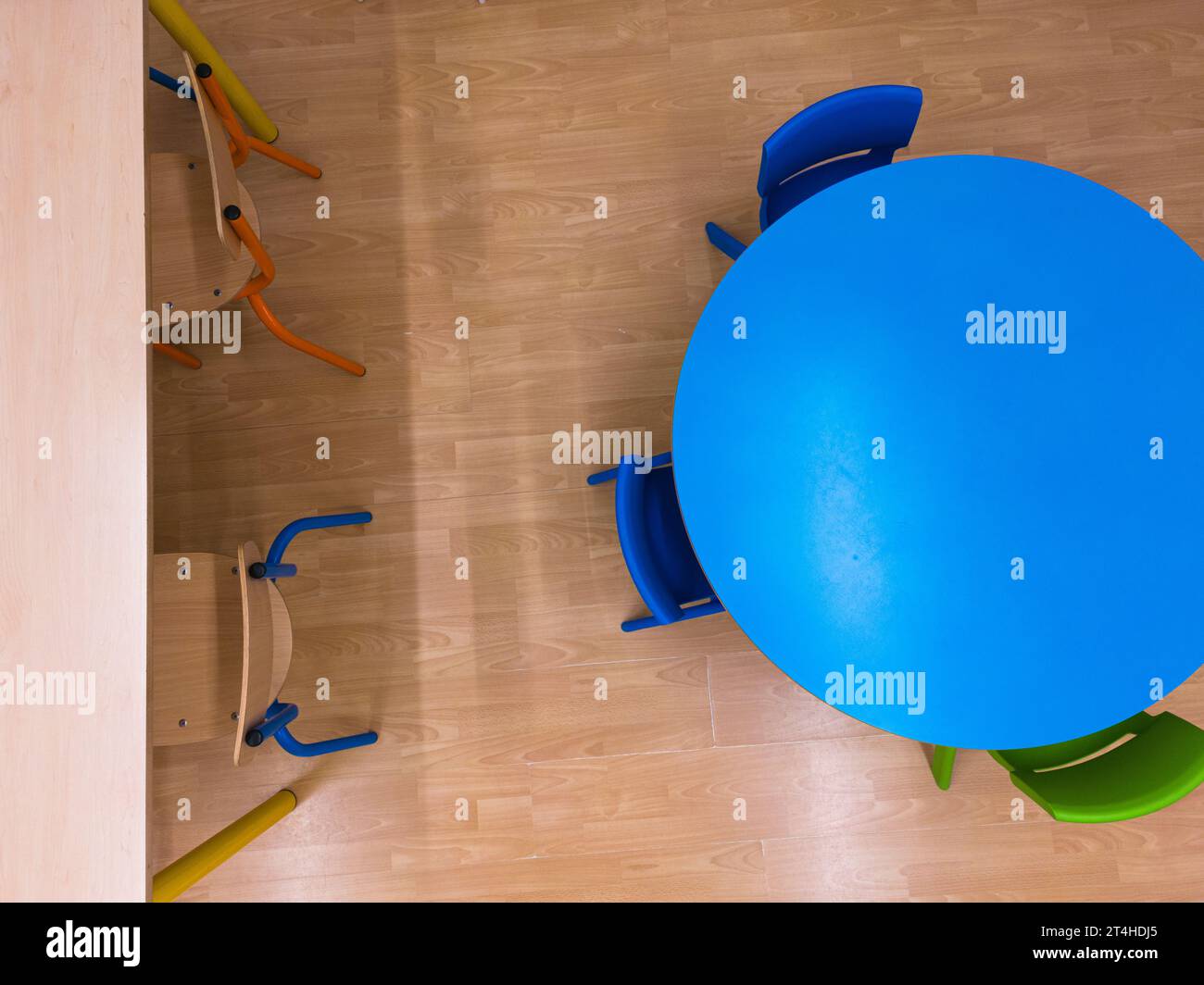 Aerial view of a school classroom, with brown and colored chairs and ...