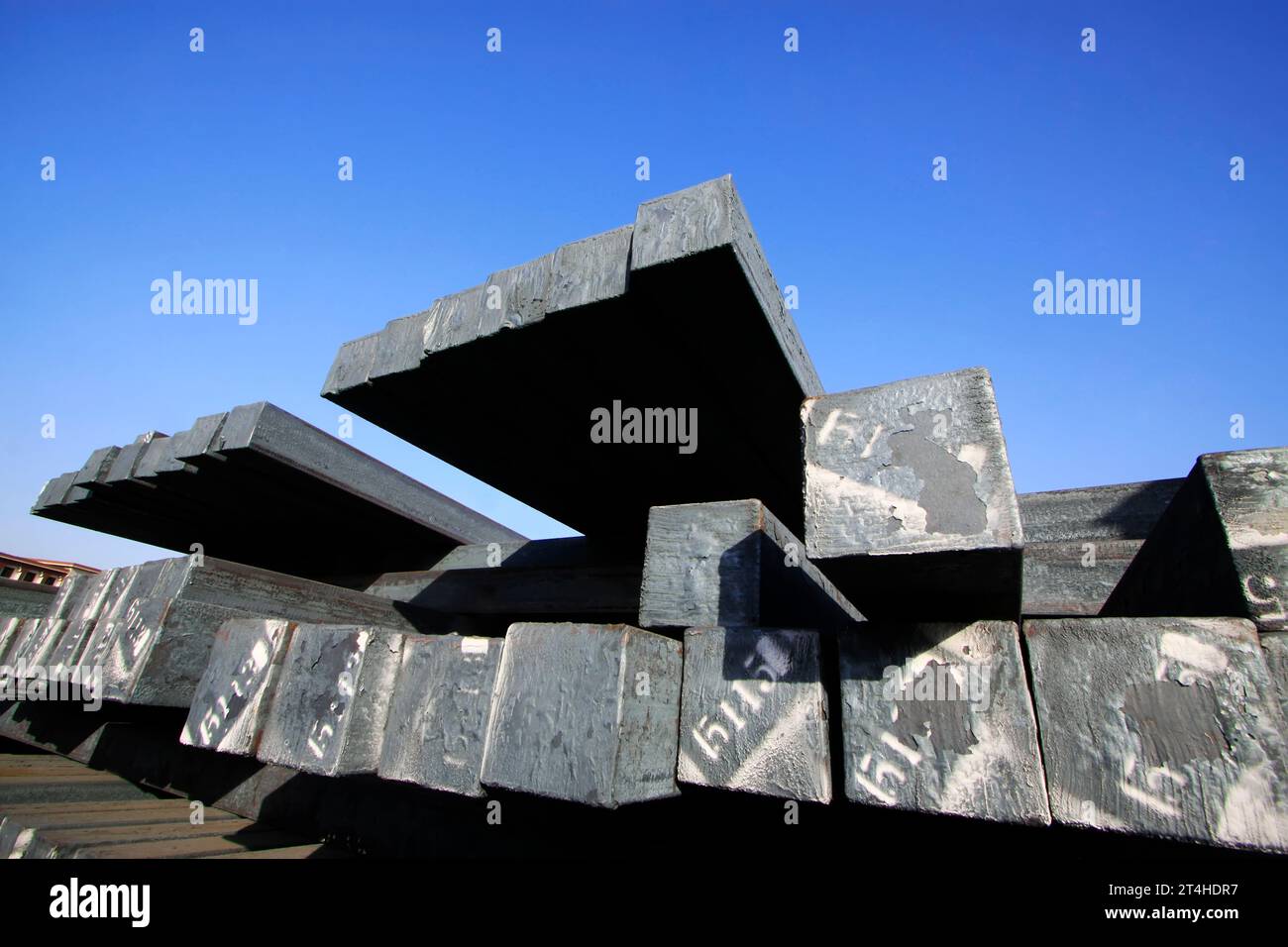 Steel ingot under the blue sky, closeup of photo Stock Photo - Alamy