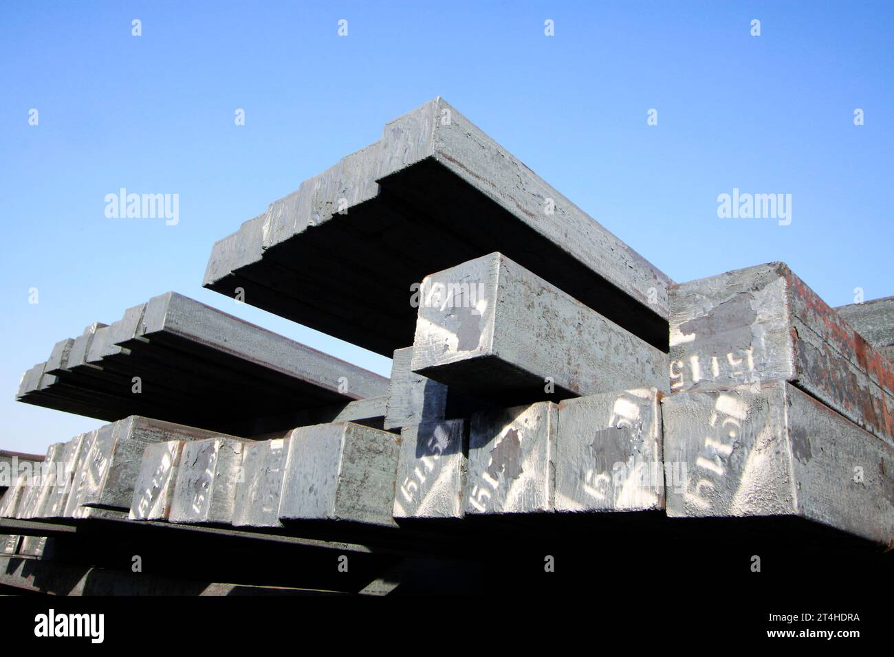 Steel ingot under the blue sky, closeup of photo Stock Photo - Alamy