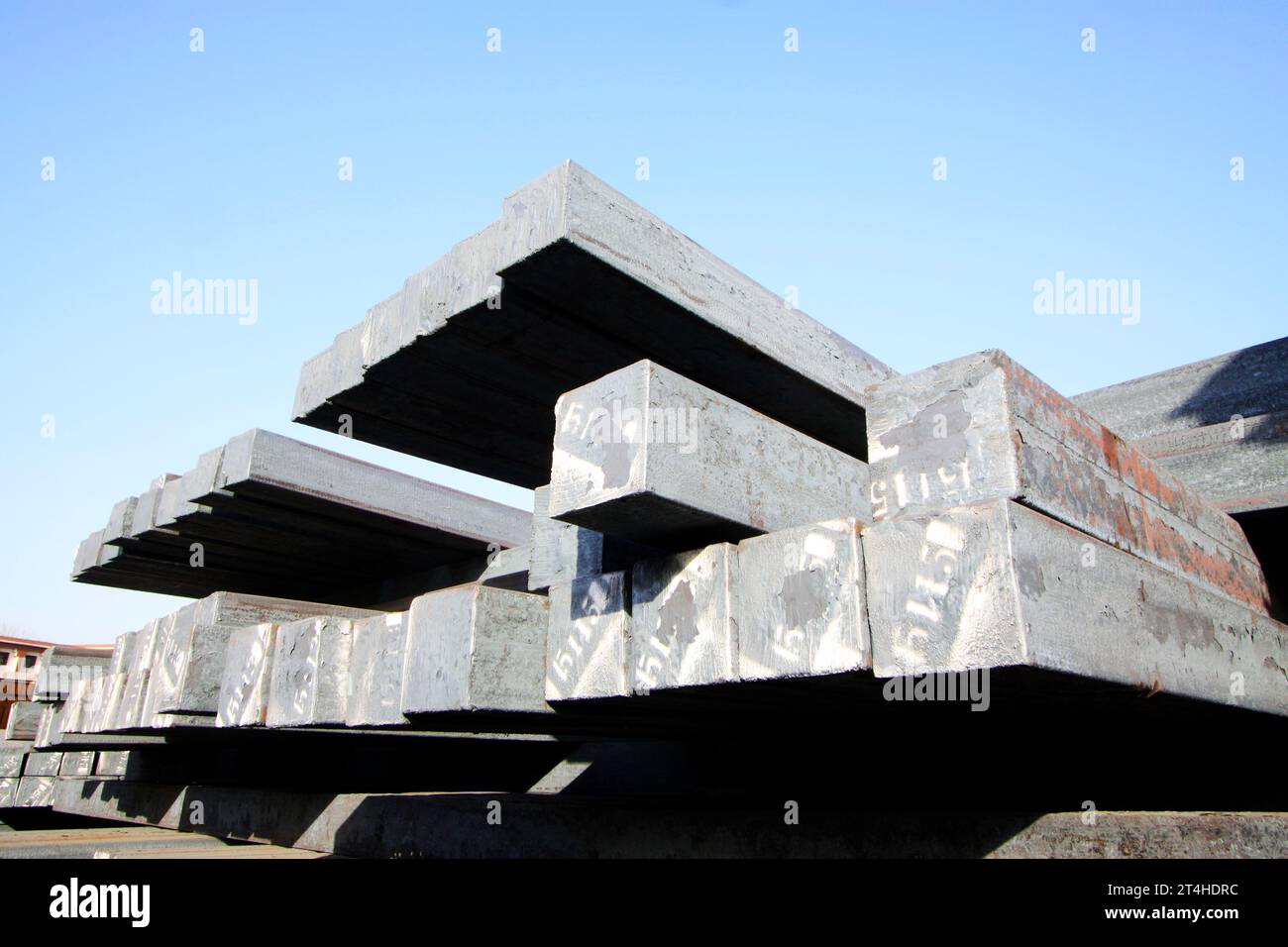 Steel ingot under the blue sky, closeup of photo Stock Photo - Alamy