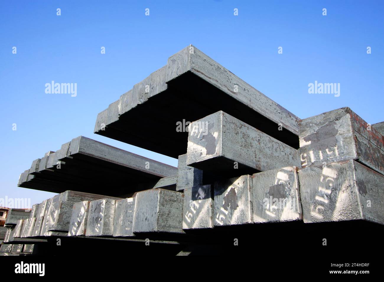 Steel ingot under the blue sky, closeup of photo Stock Photo - Alamy