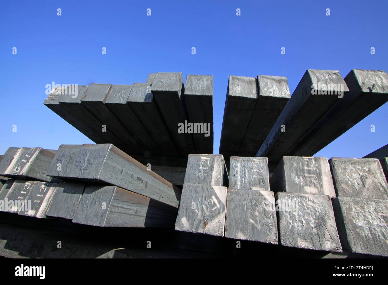 Steel ingot under the blue sky, closeup of photo Stock Photo - Alamy