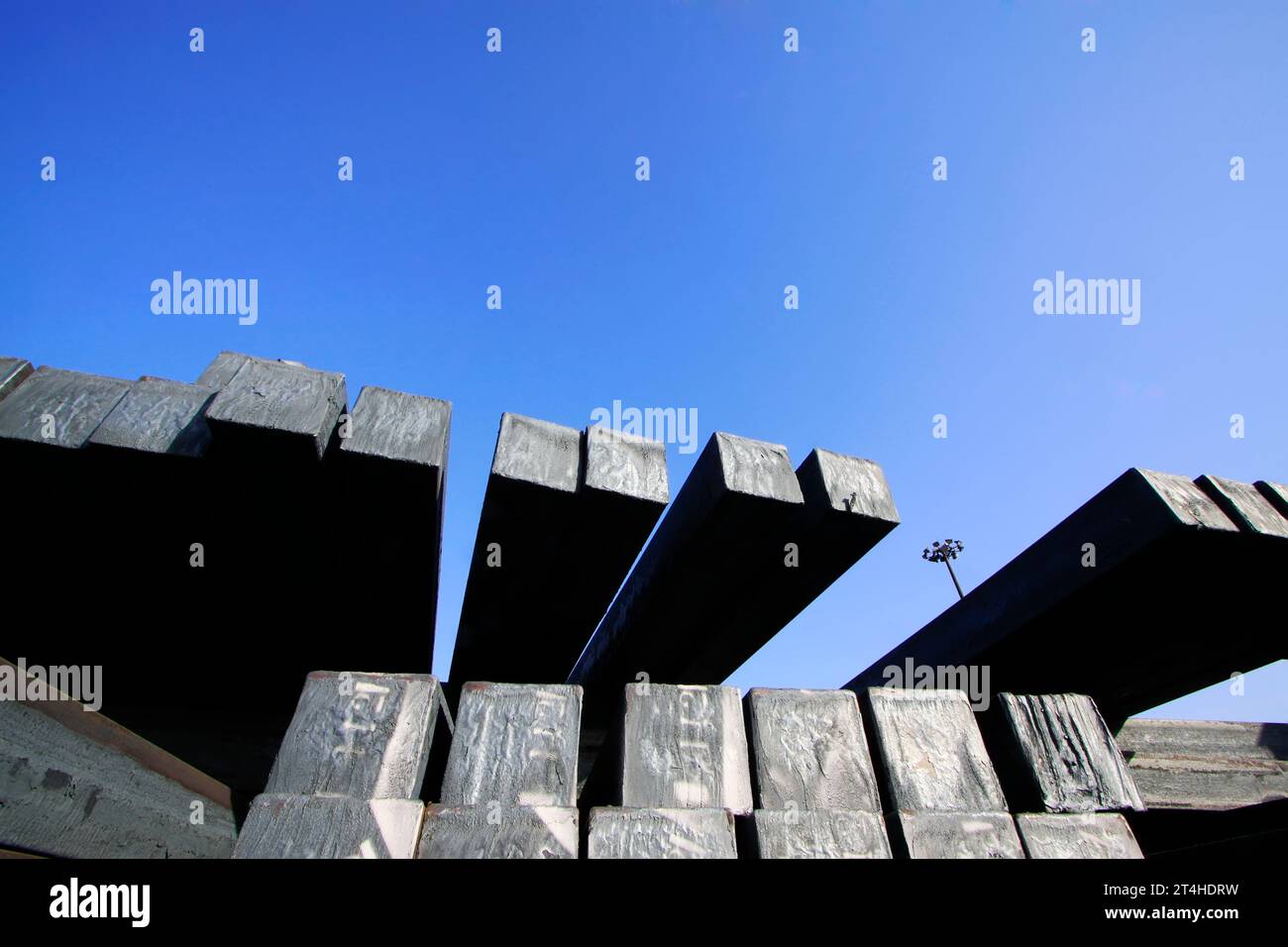 Steel ingot under the blue sky, closeup of photo Stock Photo - Alamy