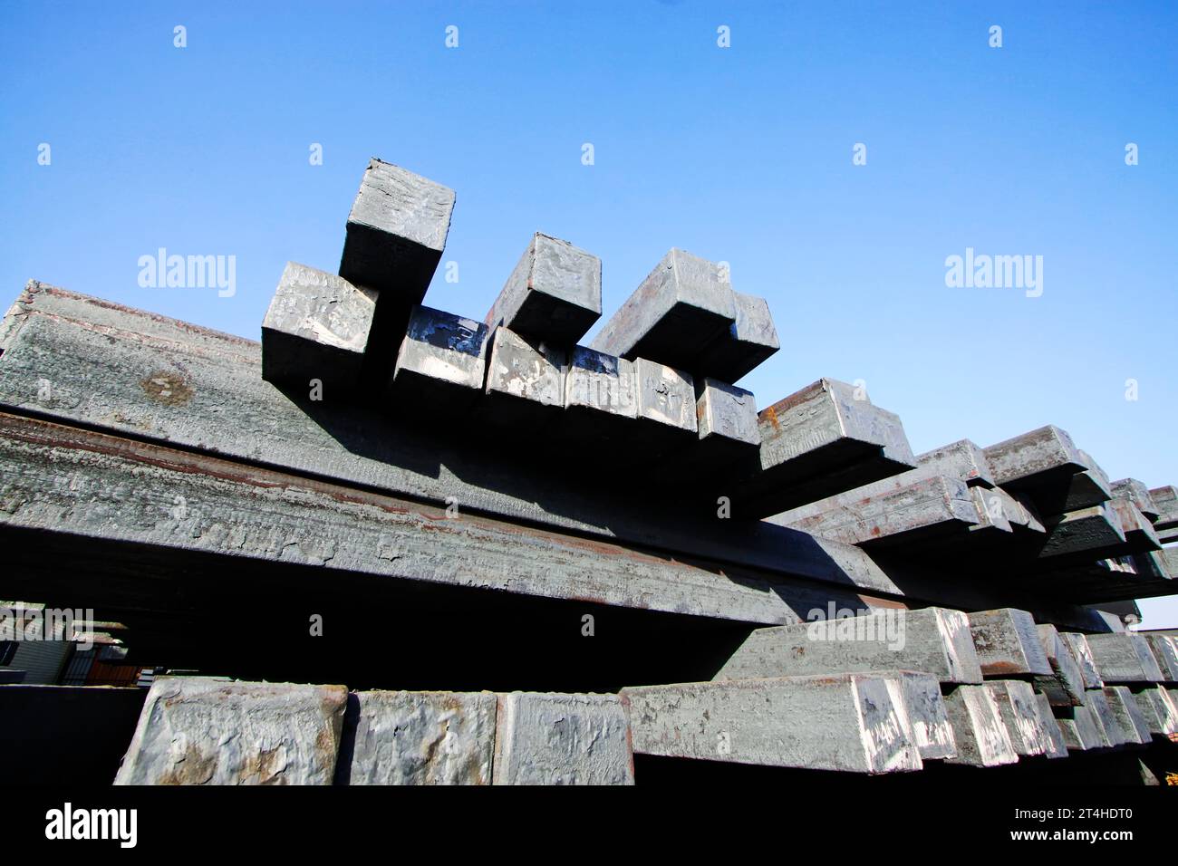 Steel ingot under the blue sky, closeup of photo Stock Photo - Alamy