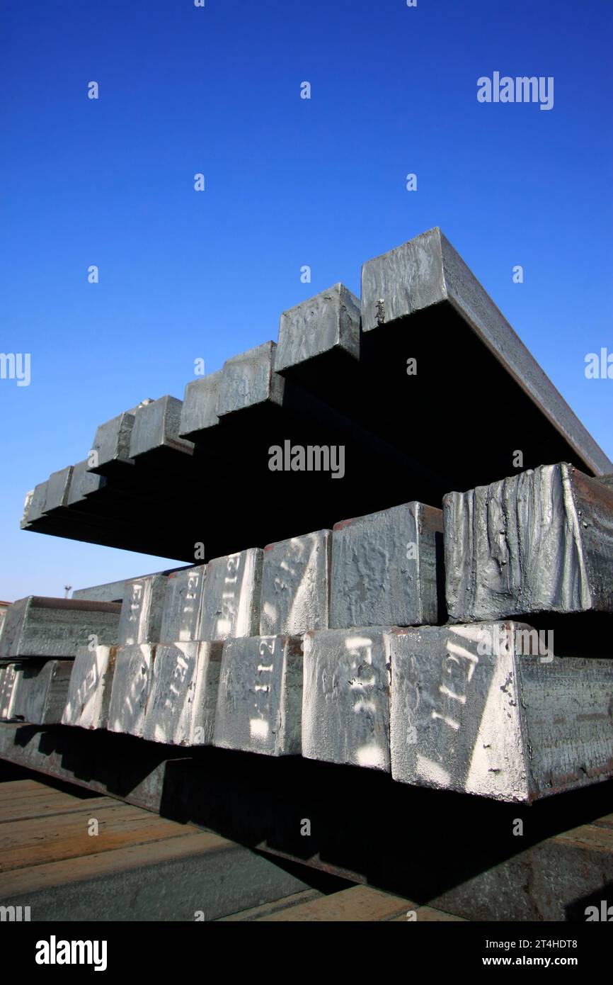 Steel ingot under the blue sky, closeup of photo Stock Photo - Alamy
