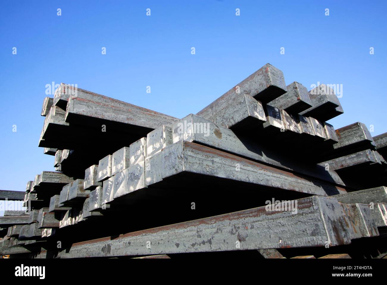 Steel ingot under the blue sky, closeup of photo Stock Photo - Alamy