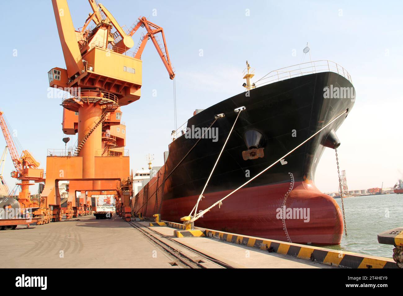 Portal crane and cargo ship, closeup of photo Stock Photo - Alamy
