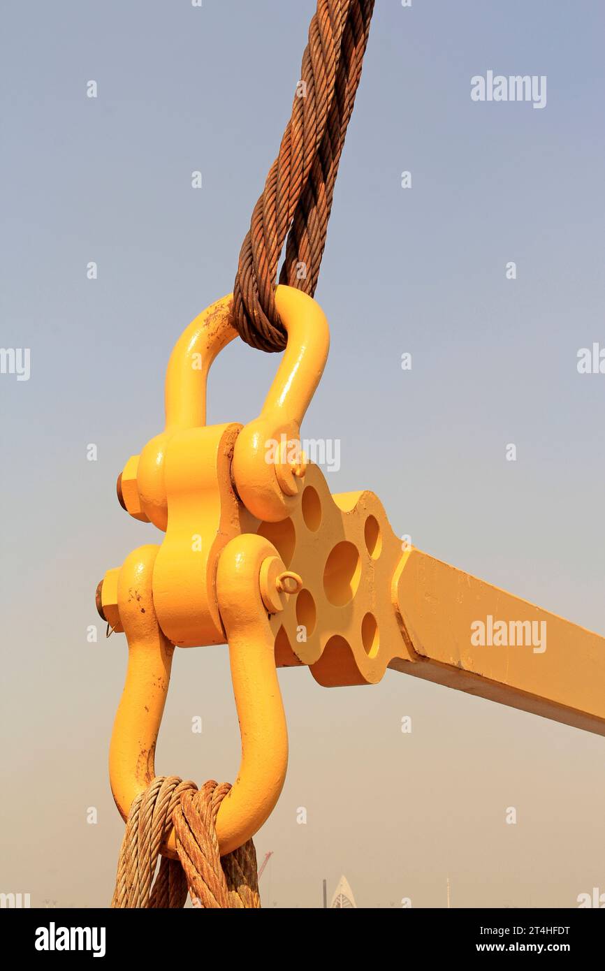 yellow metal fasteners and wire rope, closeup of photo Stock Photo - Alamy