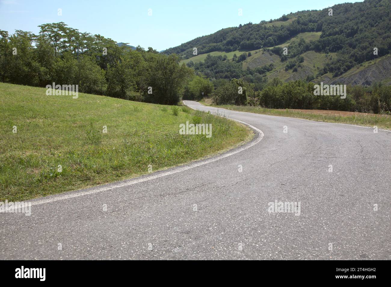 Road in a park by the hillside at sunset Stock Photo - Alamy