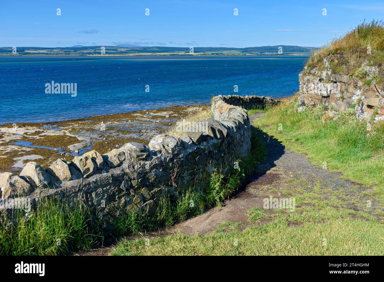 A footpath below the Heugh, Holy Island, Northumberland, England, UK ...