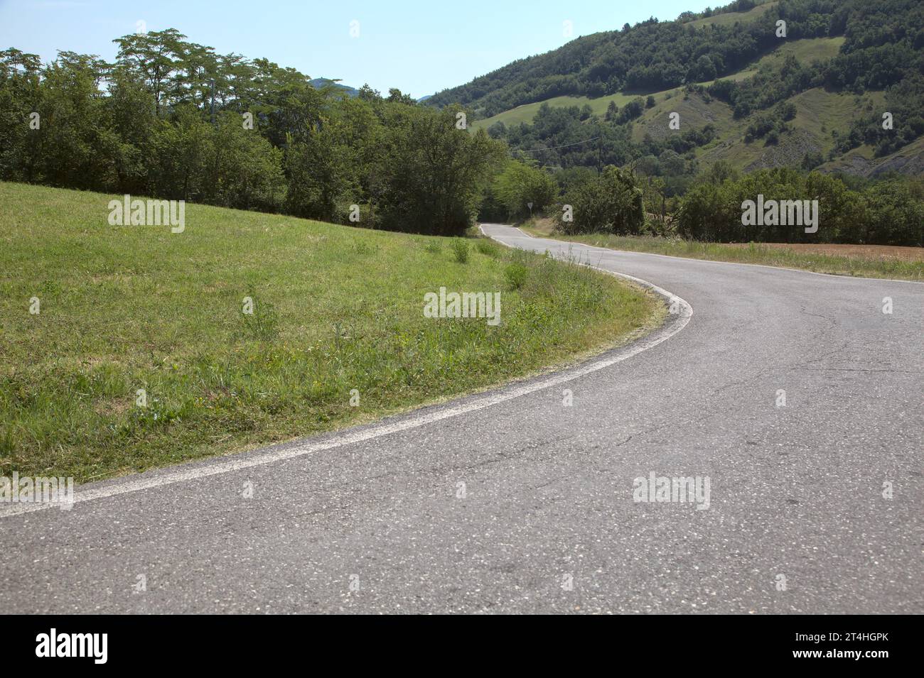 Road in a park by the hillside at sunset Stock Photo - Alamy