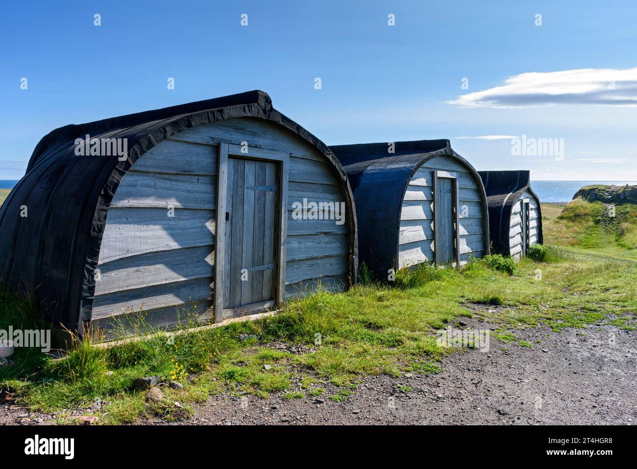 Three of the traditional sheds made from upturned boats, near the ...