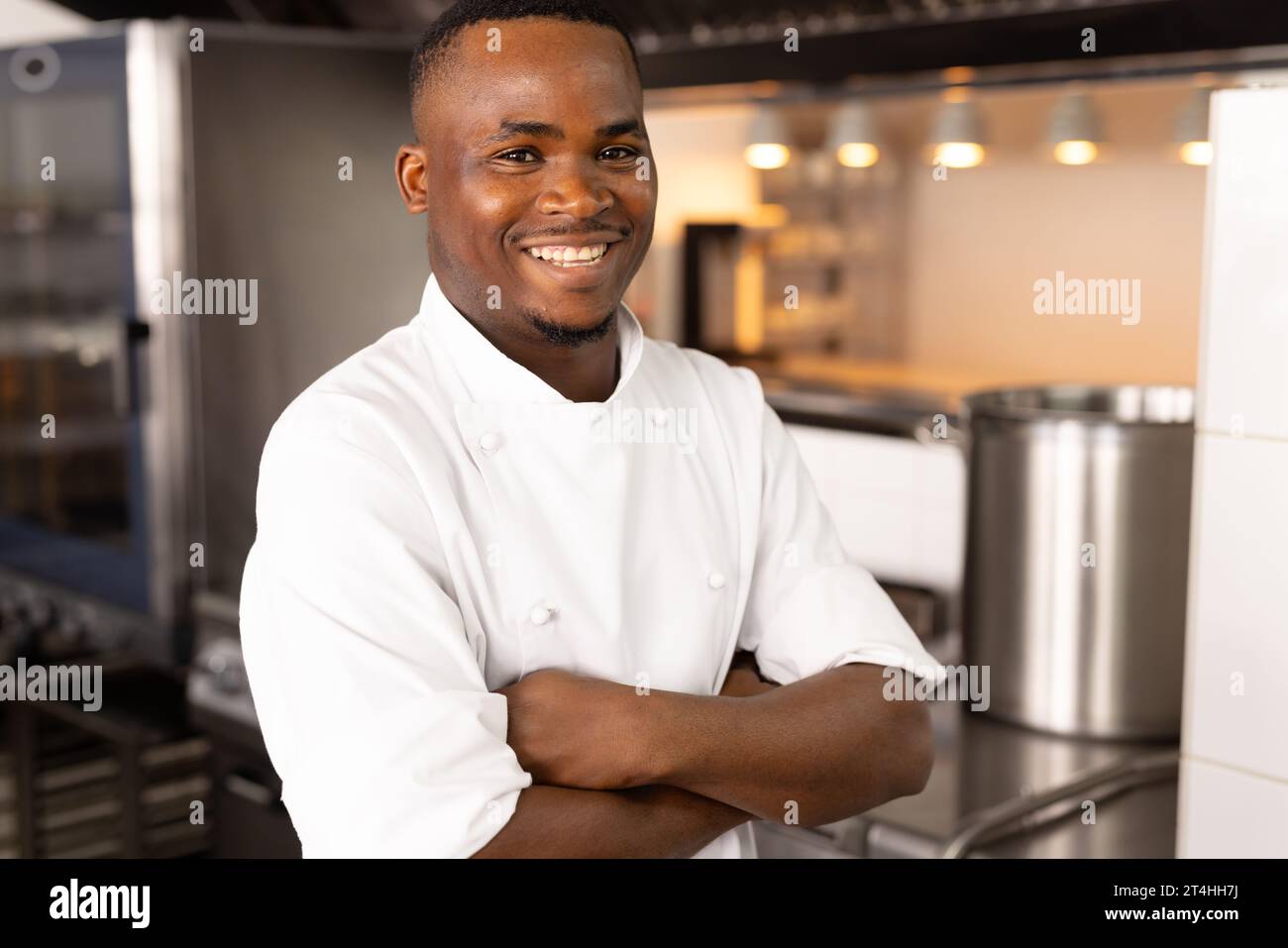 Portrait of smiling african american male chef with arms crossed ...