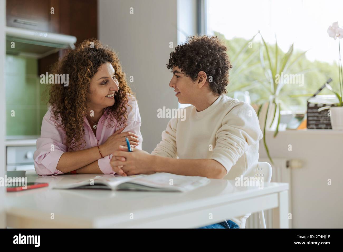 Mother helping her son with homework at home Stock Photo - Alamy